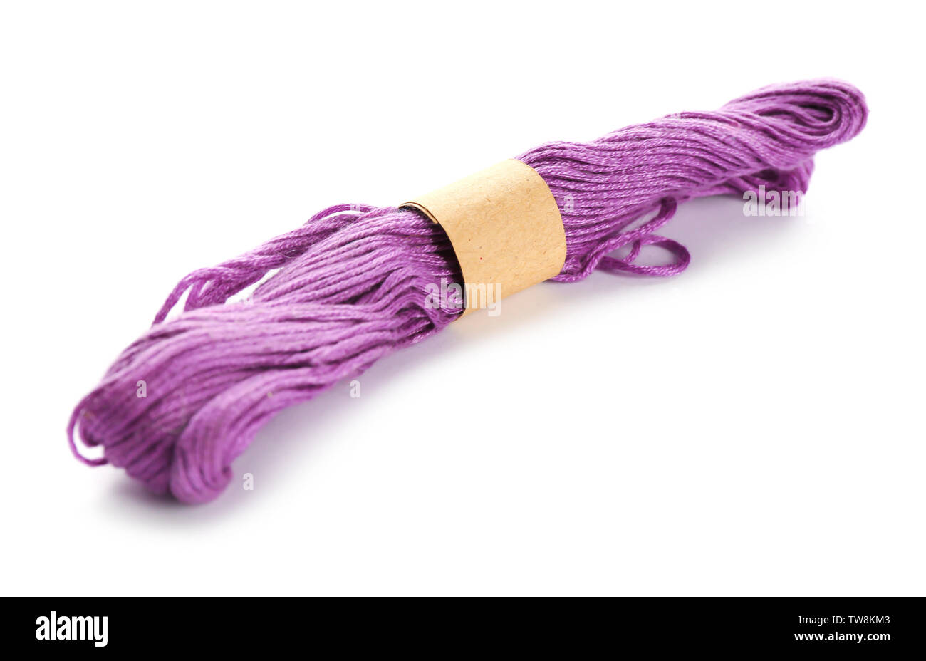 Violet embroidery thread on white background Stock Photo - Alamy