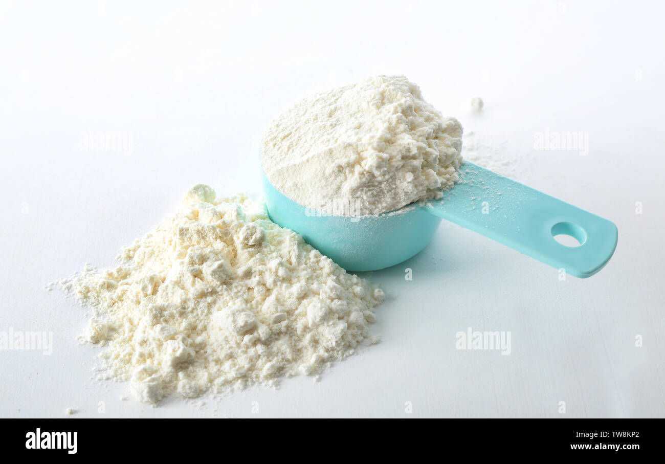 Measuring scoop and protein powder on white background Stock Photo - Alamy