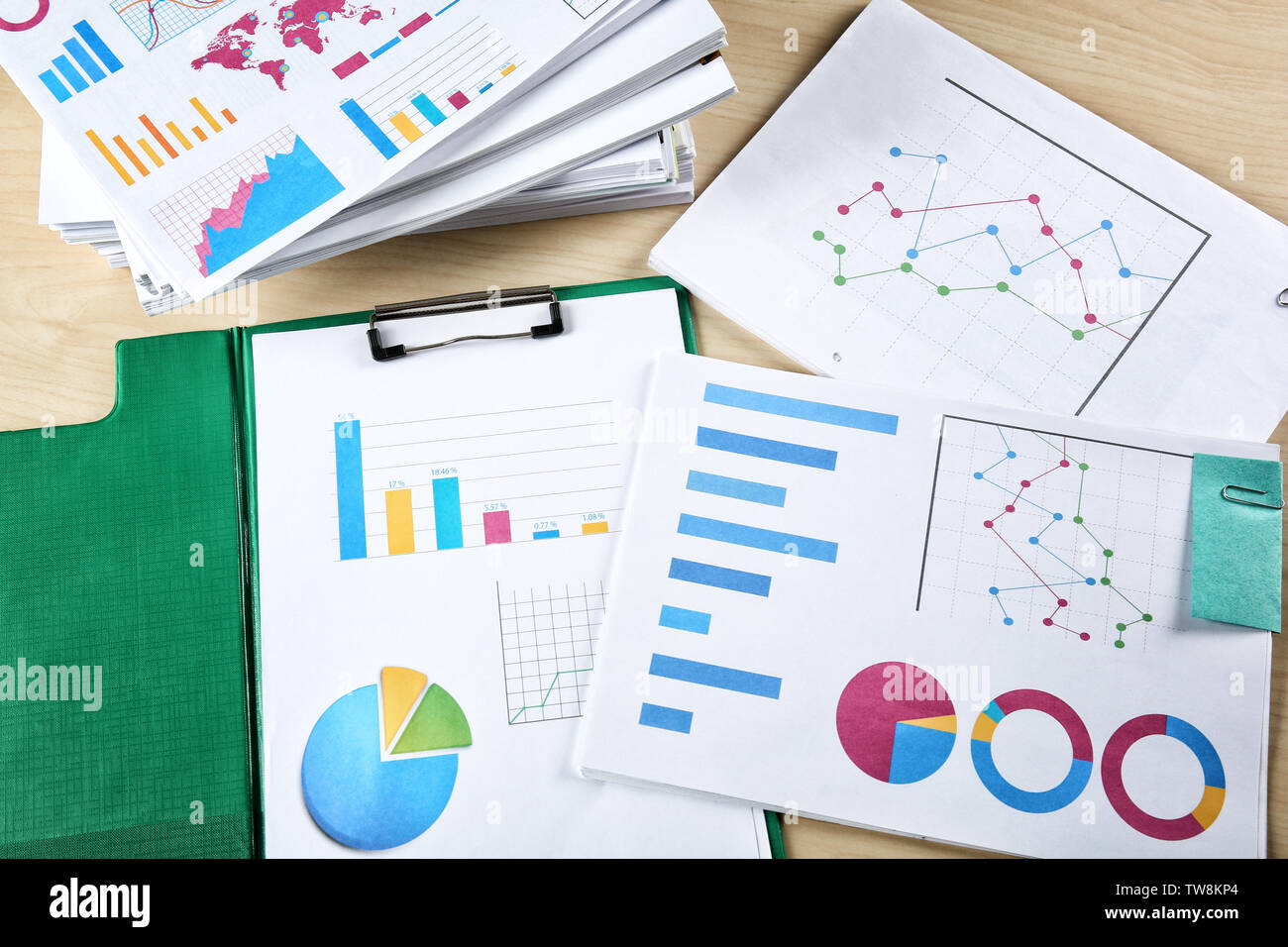 Documents with graphs and charts on table Stock Photo - Alamy