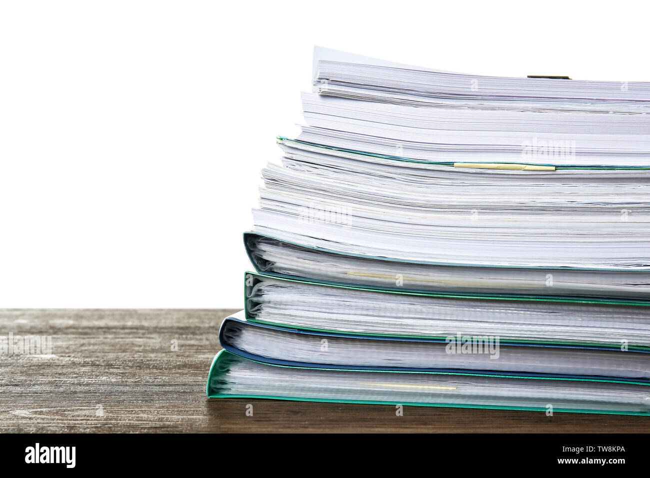 Stack of documents on table against white background Stock Photo - Alamy