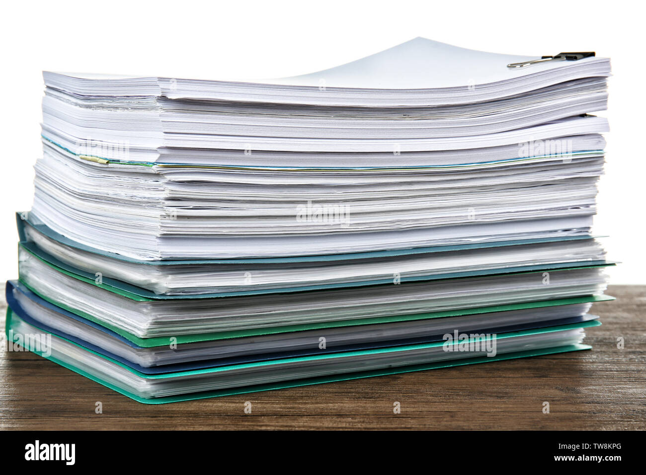 Stack of documents on table against white background Stock Photo - Alamy