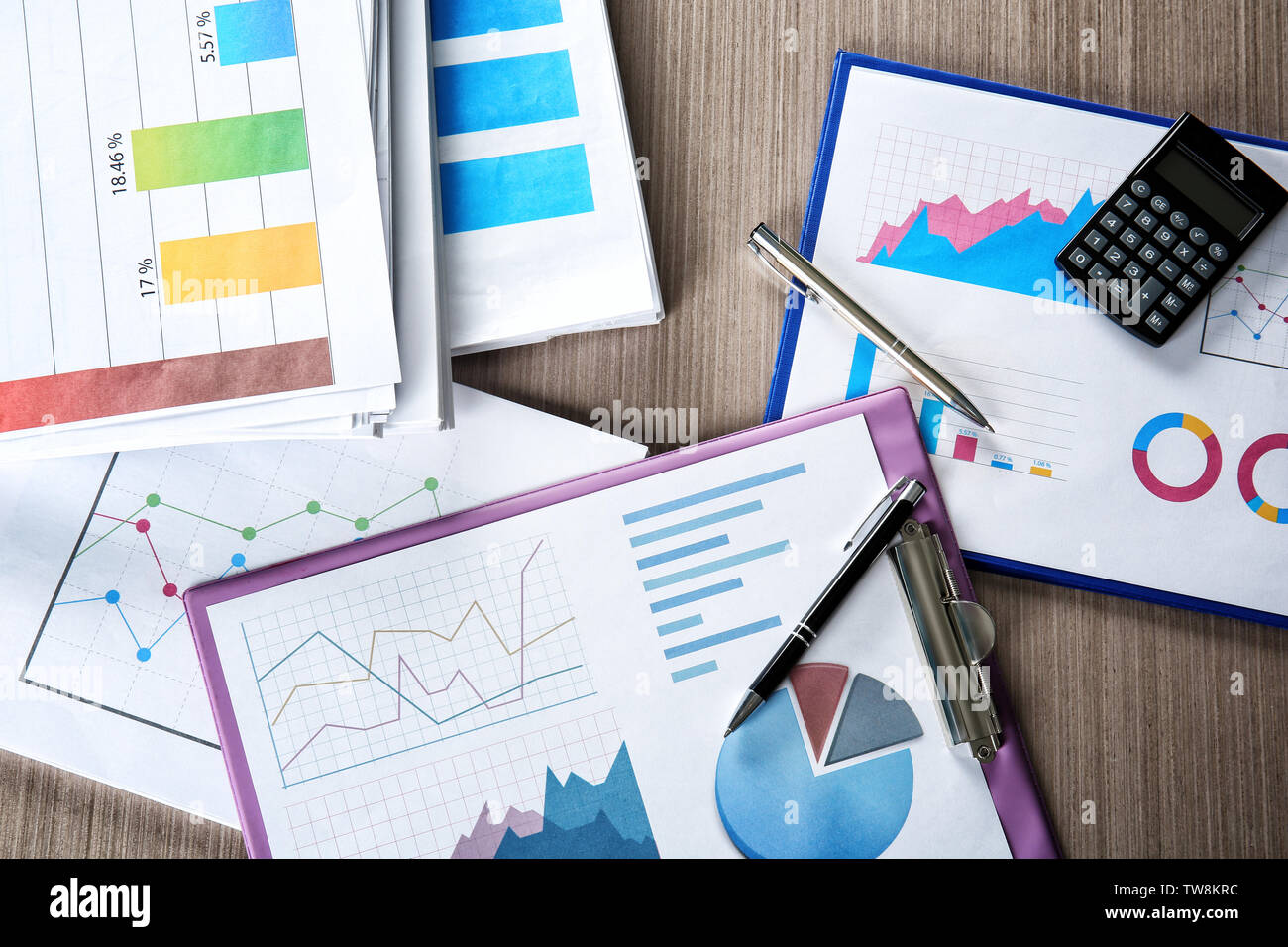 Documents with graphs and charts on table Stock Photo - Alamy