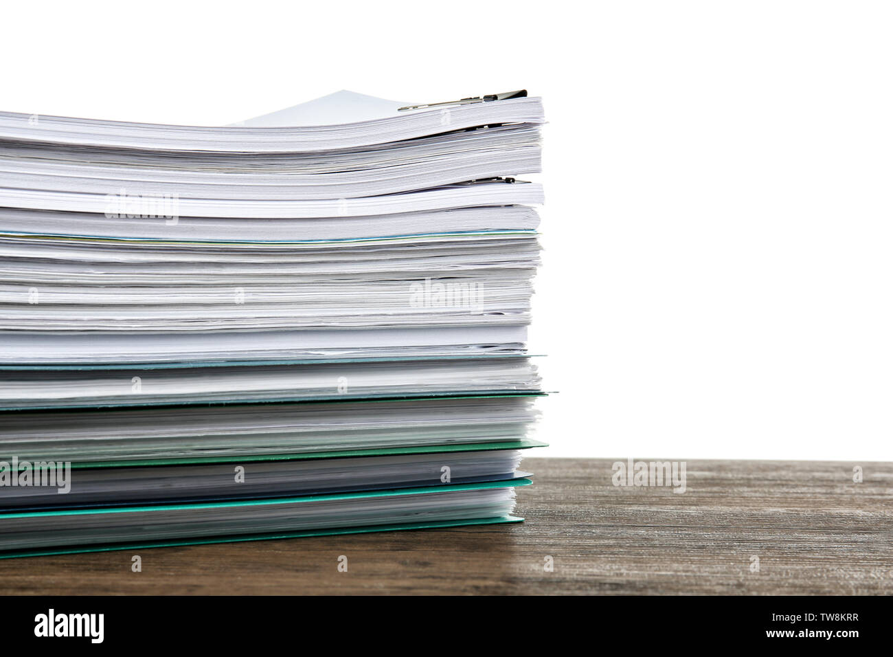 Stack of documents on table against white background Stock Photo - Alamy