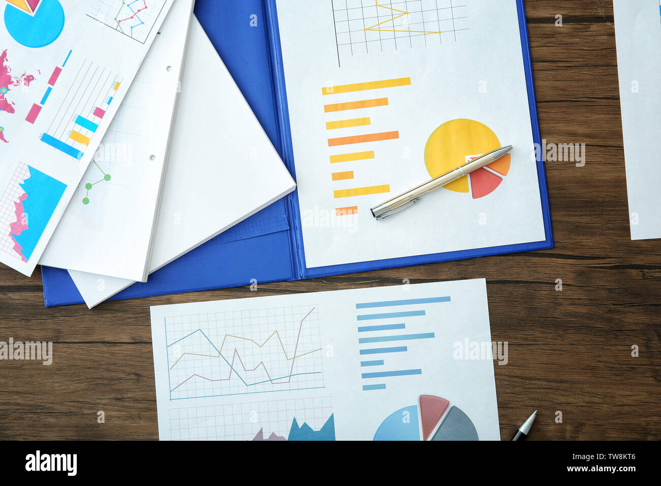 Documents with graphs and charts on table Stock Photo - Alamy