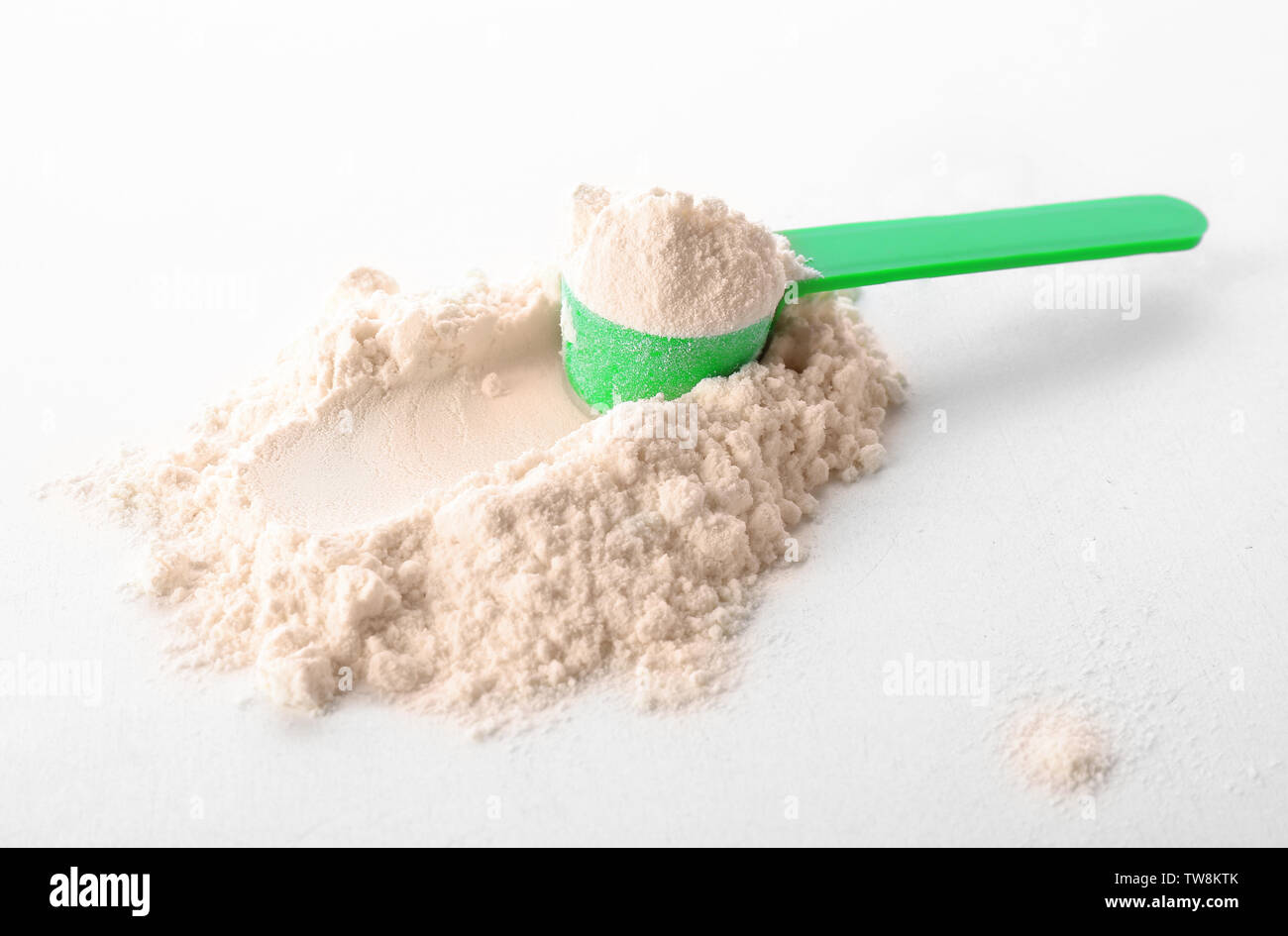 Measuring scoop and protein powder on white background Stock Photo - Alamy