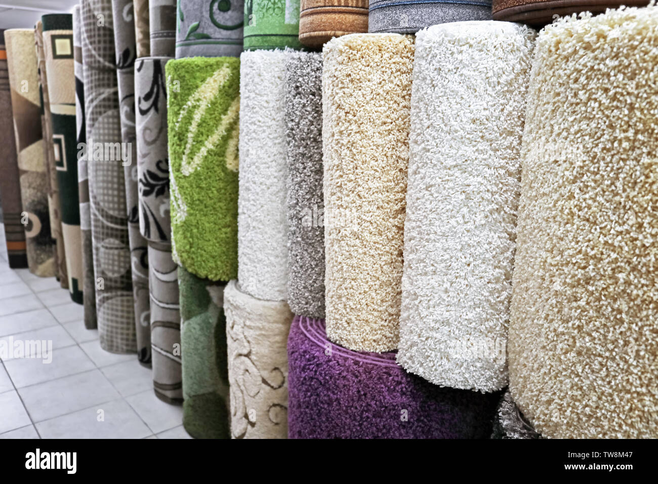 Assortment of different carpets in store Stock Photo - Alamy