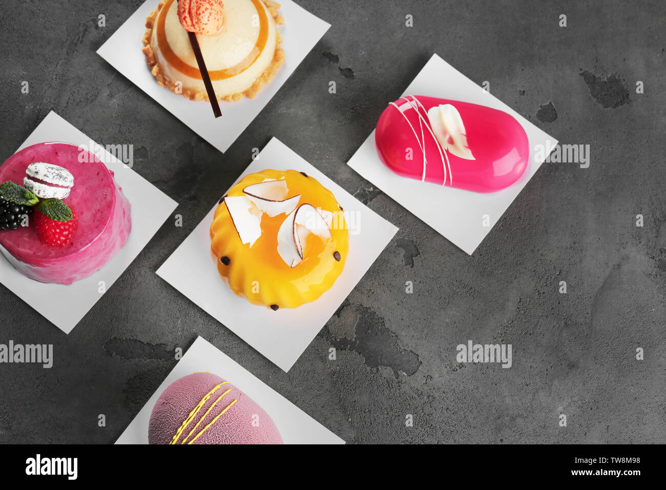 Various tasty cakes on grunge background Stock Photo - Alamy