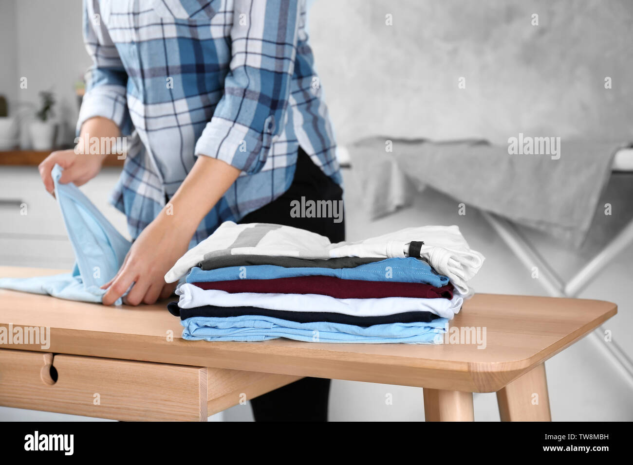 Woman folding laundry folding clothes hi-res stock photography and ...