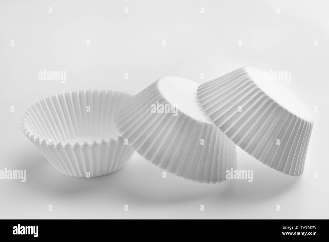 Forms for baking cupcakes on white background Stock Photo - Alamy