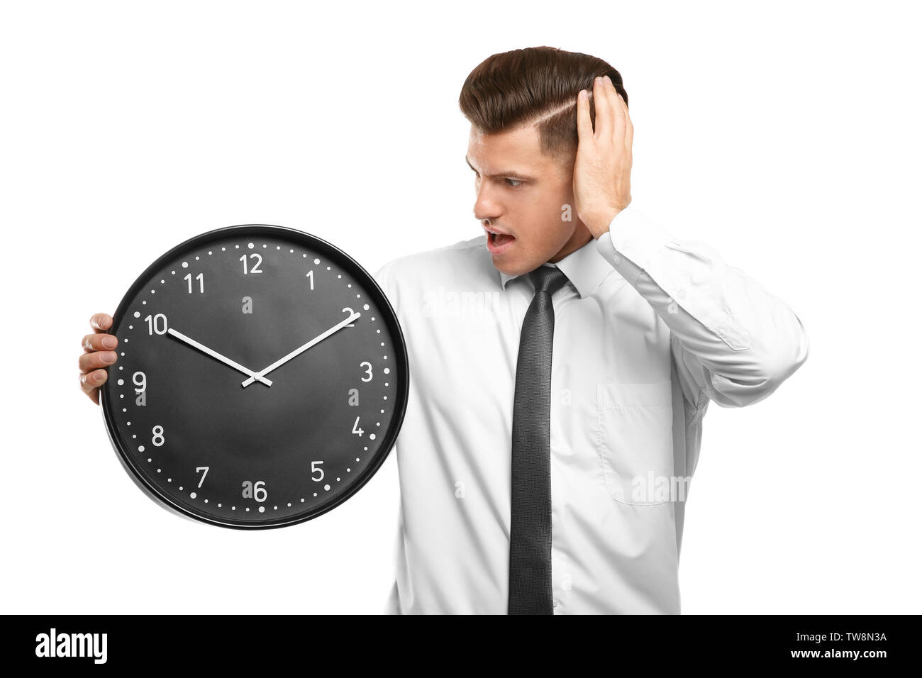 Shocked manager with clock on white background Stock Photo - Alamy