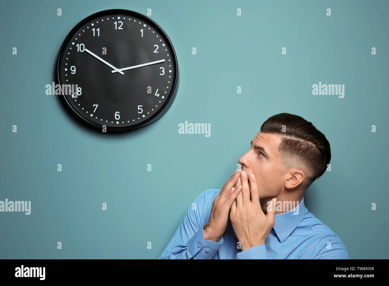 Man hanging on clock hi-res stock photography and images - Alamy