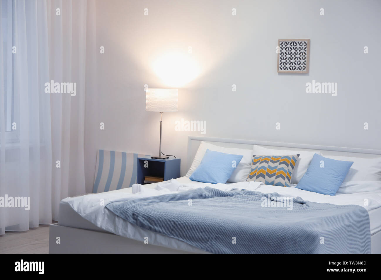 Modern bedroom interior with large bed Stock Photo - Alamy