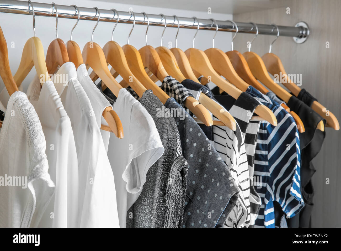 Female clothes on hangers in wardrobe Stock Photo - Alamy