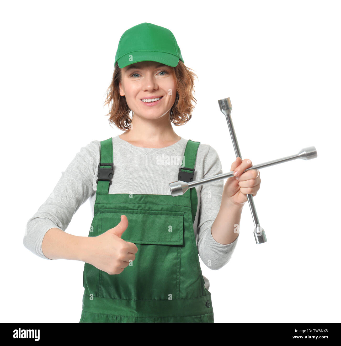 Female auto mechanic with lug wrench on white background Stock Photo ...