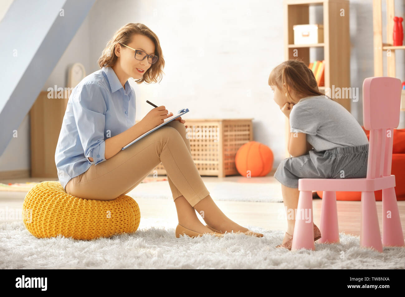 Female psychologist working with cute little girl in office Stock Photo ...