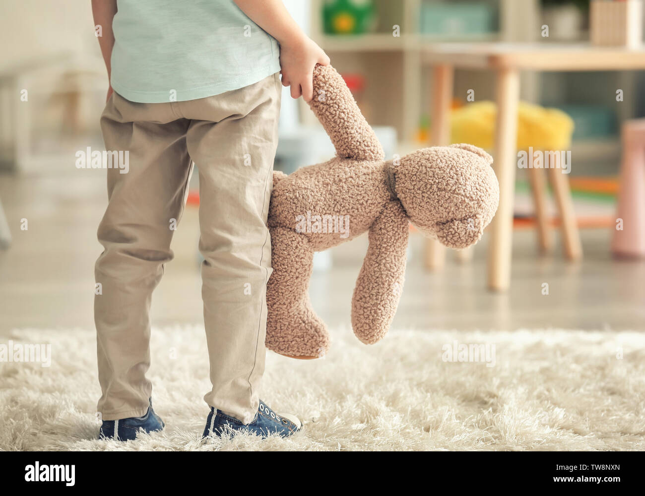 Little girl with teddy bear at home. Autism concept Stock Photo - Alamy