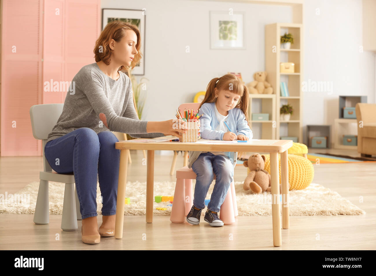 Female psychologist with cute little girl during art therapy Stock ...