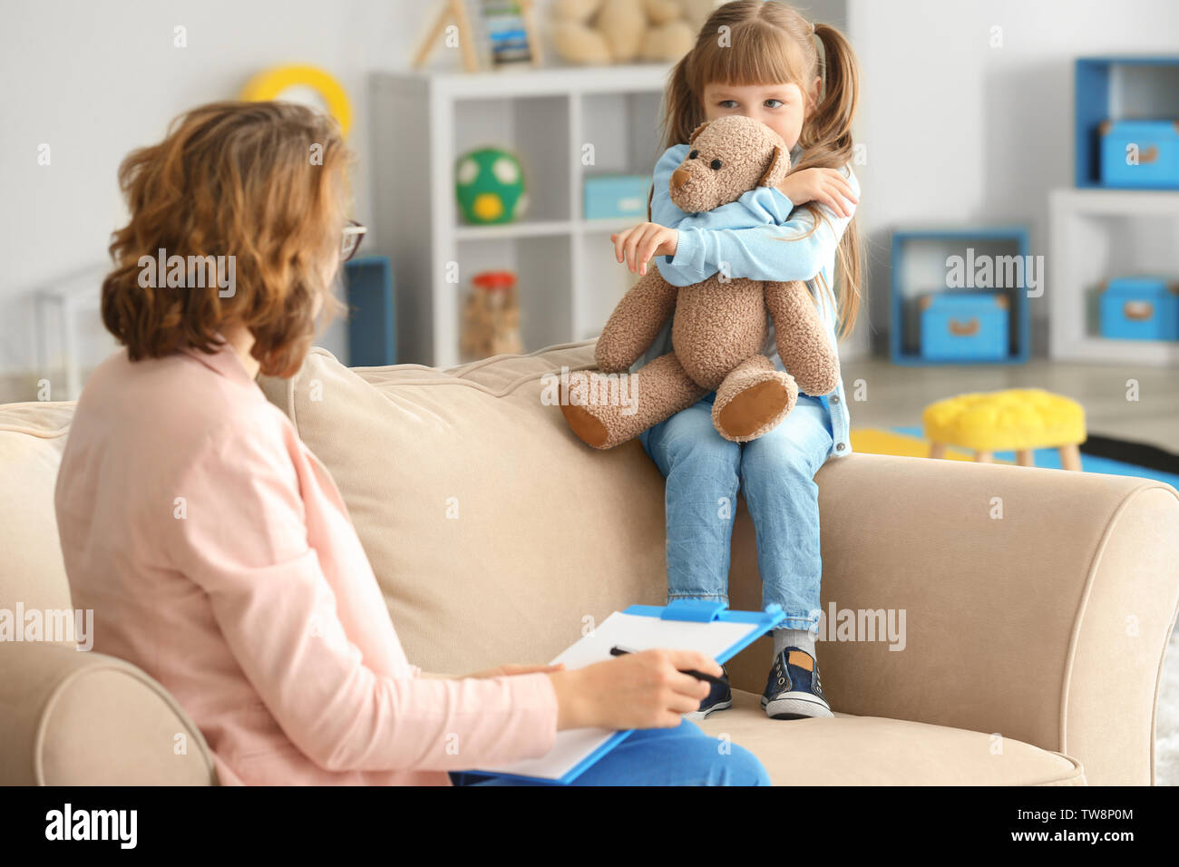 Female psychologist working with cute little girl in office Stock Photo ...