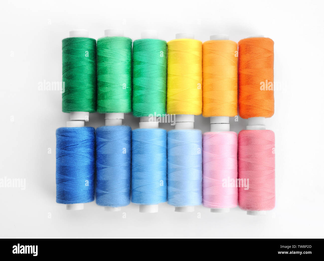 Colorful sewing threads on white background Stock Photo - Alamy