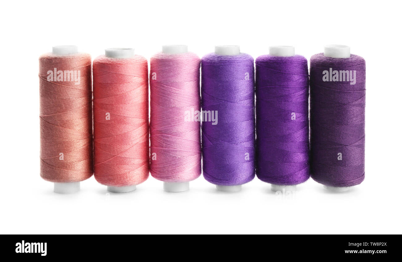 Colorful sewing threads on white background Stock Photo - Alamy