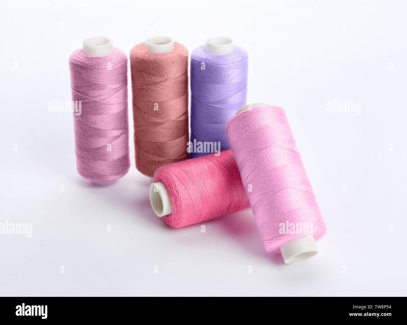 Colorful sewing threads on white background Stock Photo - Alamy