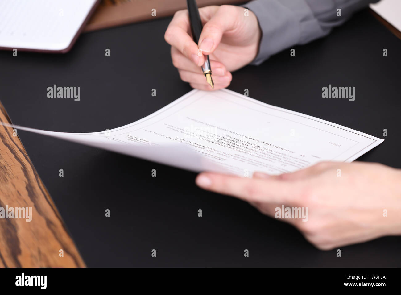 Female notary signing document, closeup Stock Photo - Alamy