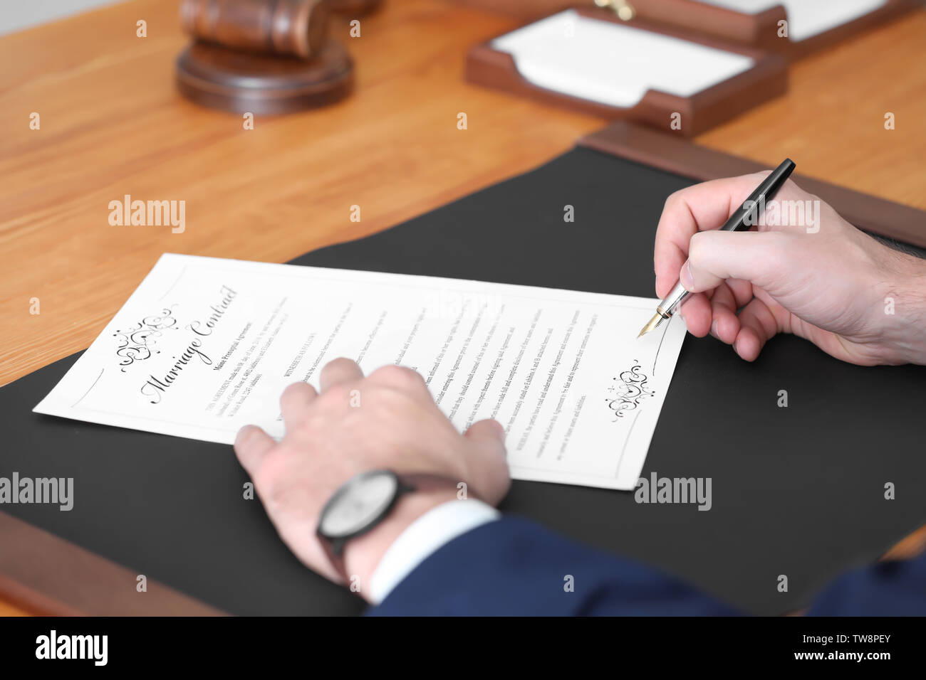 Male notary signing marriage contract, closeup Stock Photo - Alamy