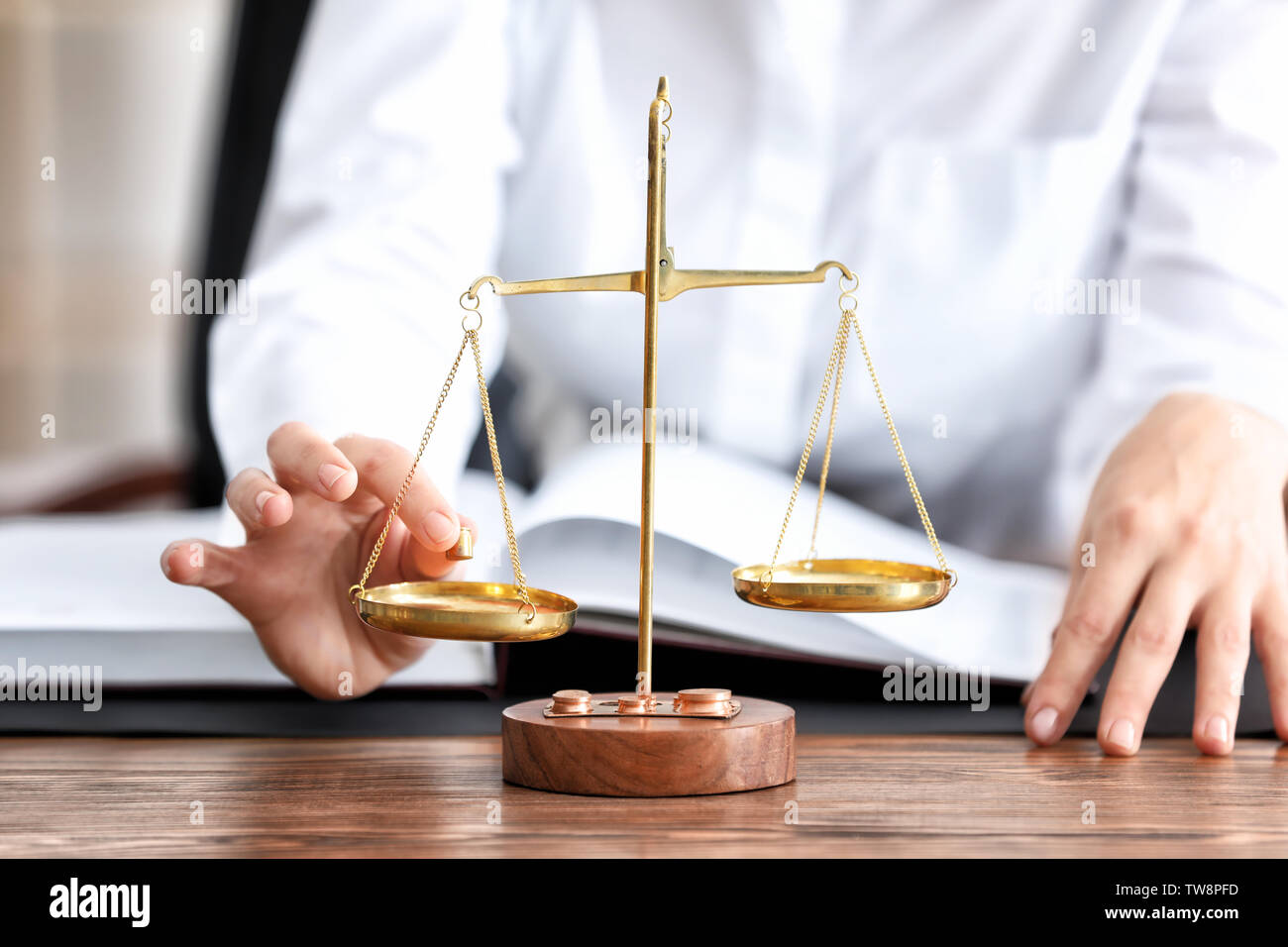 Female notary with scales of justice in office, closeup Stock Photo - Alamy