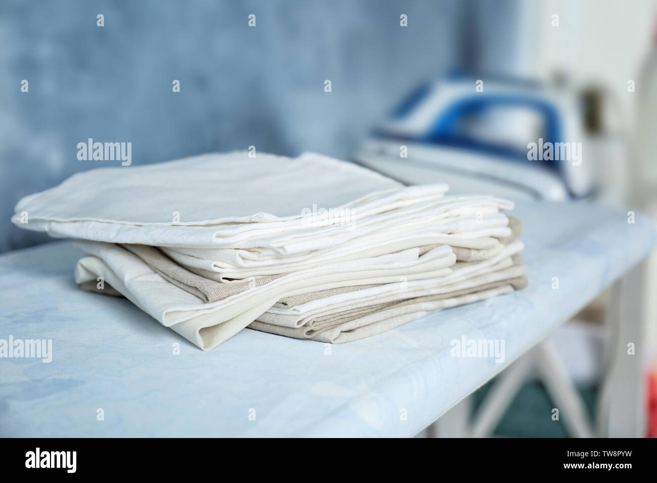Stack of clean white napkins on ironing board, closeup Stock Photo - Alamy