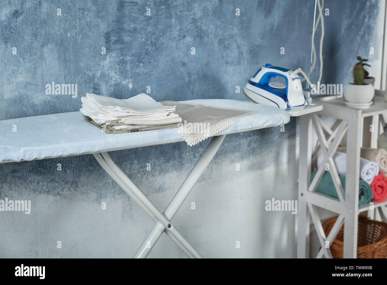Stack of clean white napkins on ironing board indoors Stock Photo - Alamy