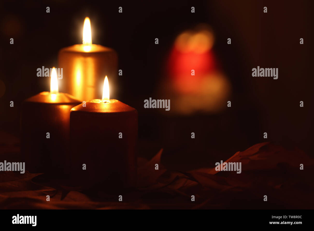 Beautiful burning candles in darkness Stock Photo - Alamy