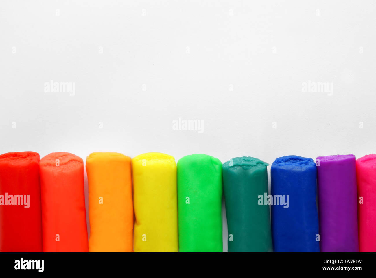 Rainbow play dough on white background Stock Photo - Alamy