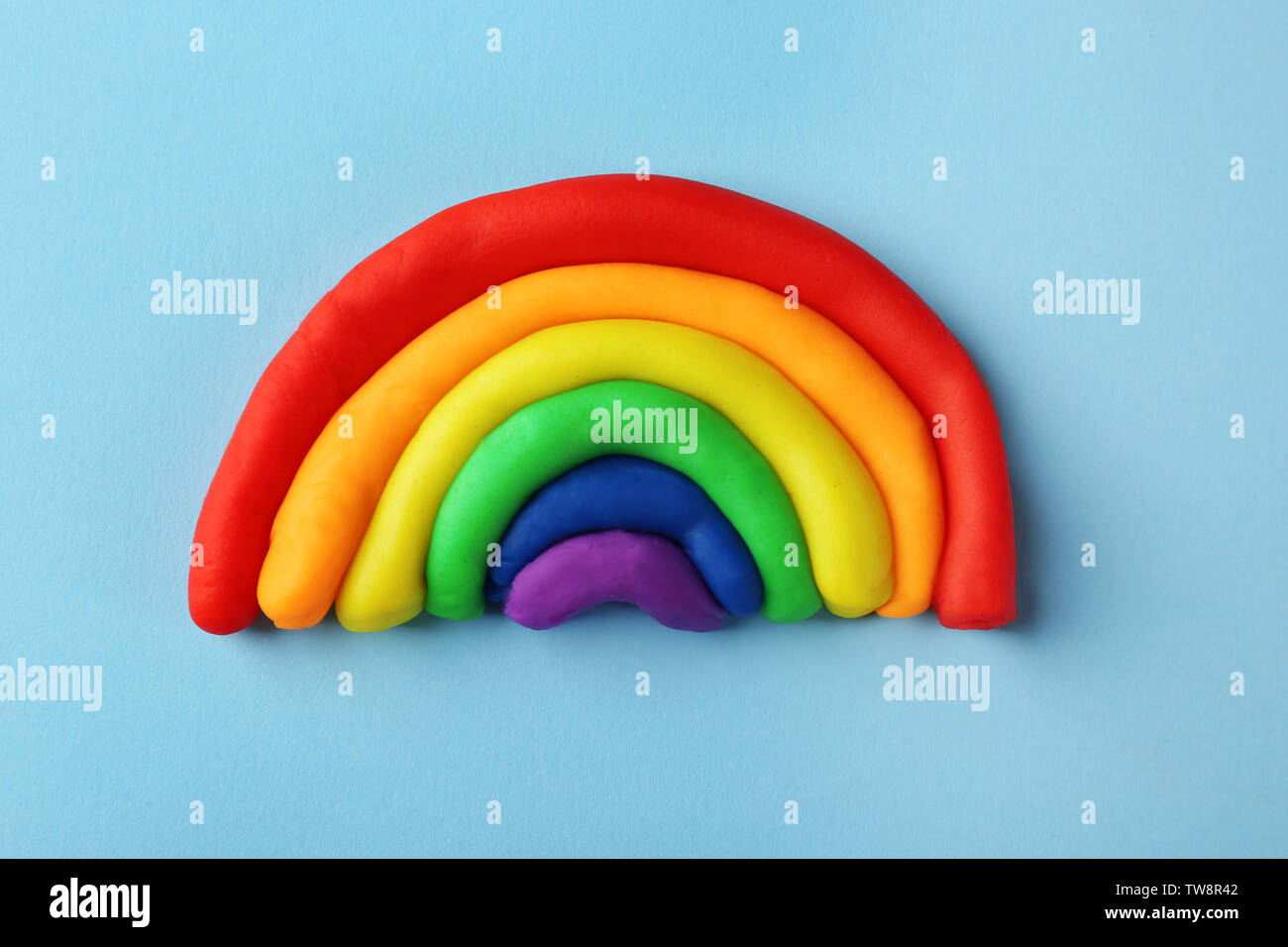 Plasticine rainbow on color background Stock Photo - Alamy