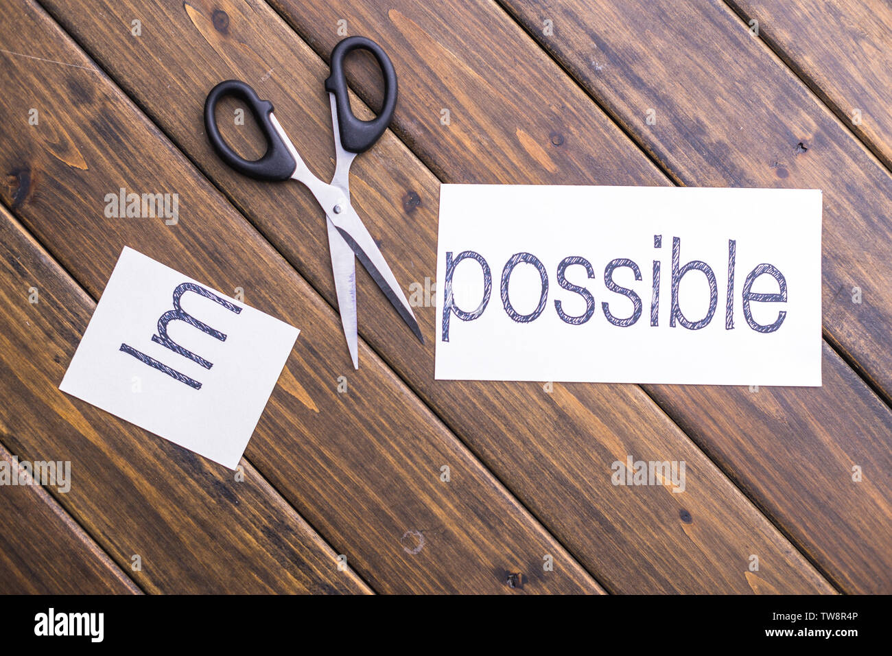 Cutting paper with word is impossible Stock Photo - Alamy