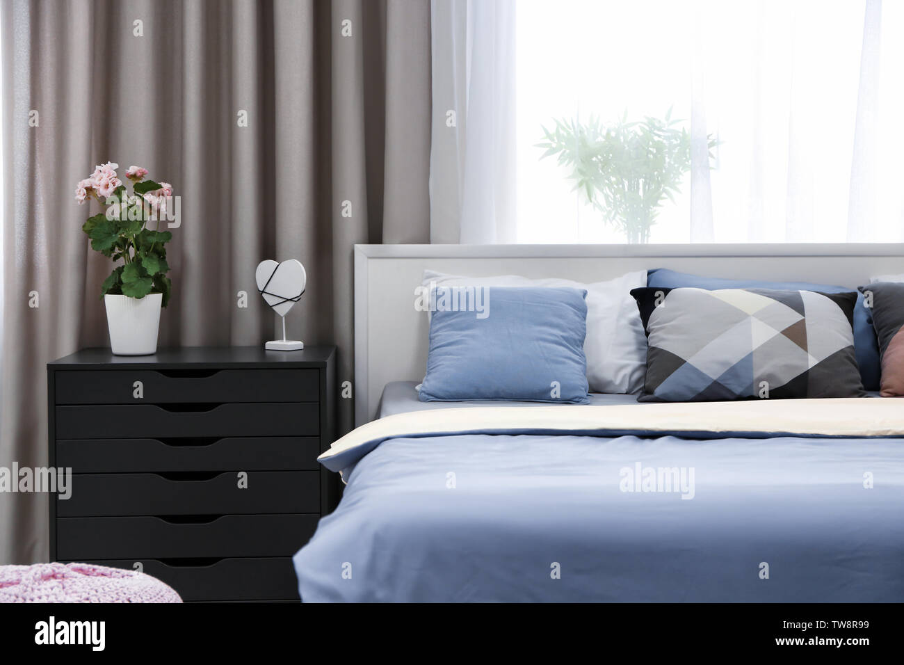 Modern bedroom interior with comfortable bed Stock Photo - Alamy