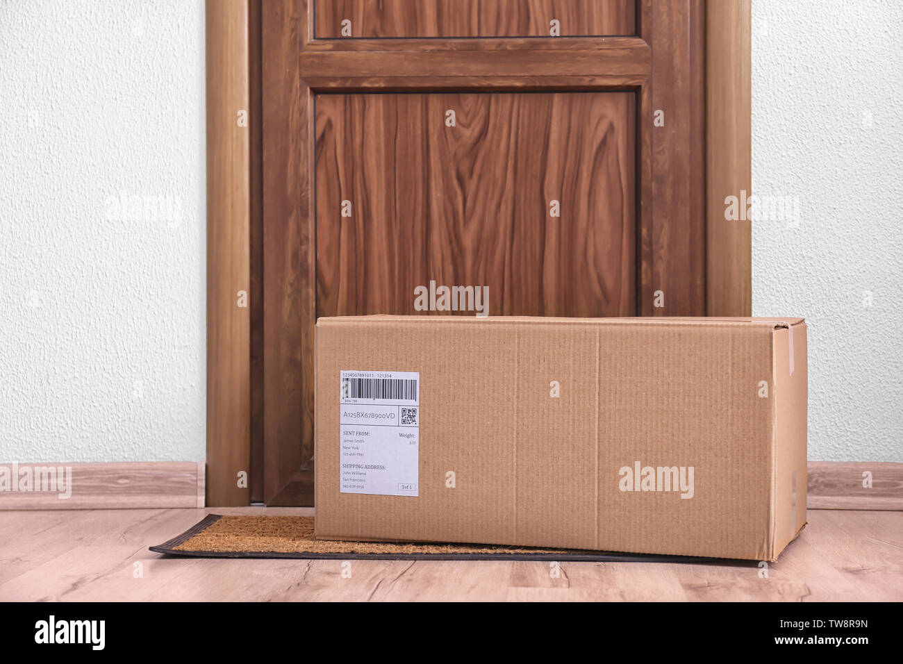 Parcel box on floor near door Stock Photo - Alamy