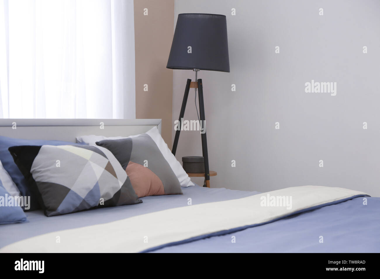 Modern bedroom interior with comfortable bed Stock Photo - Alamy