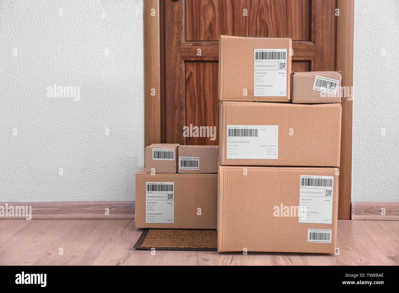 Parcel boxes on floor near door Stock Photo - Alamy