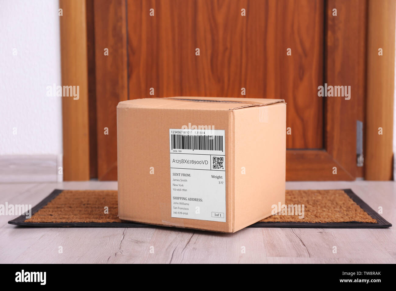 Parcel box on floor near door Stock Photo - Alamy
