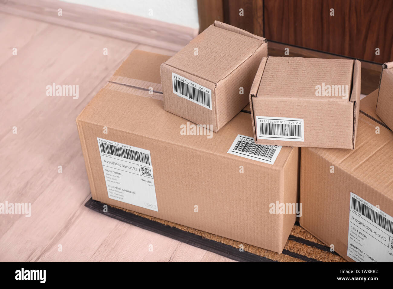 Parcel boxes on floor near door Stock Photo - Alamy