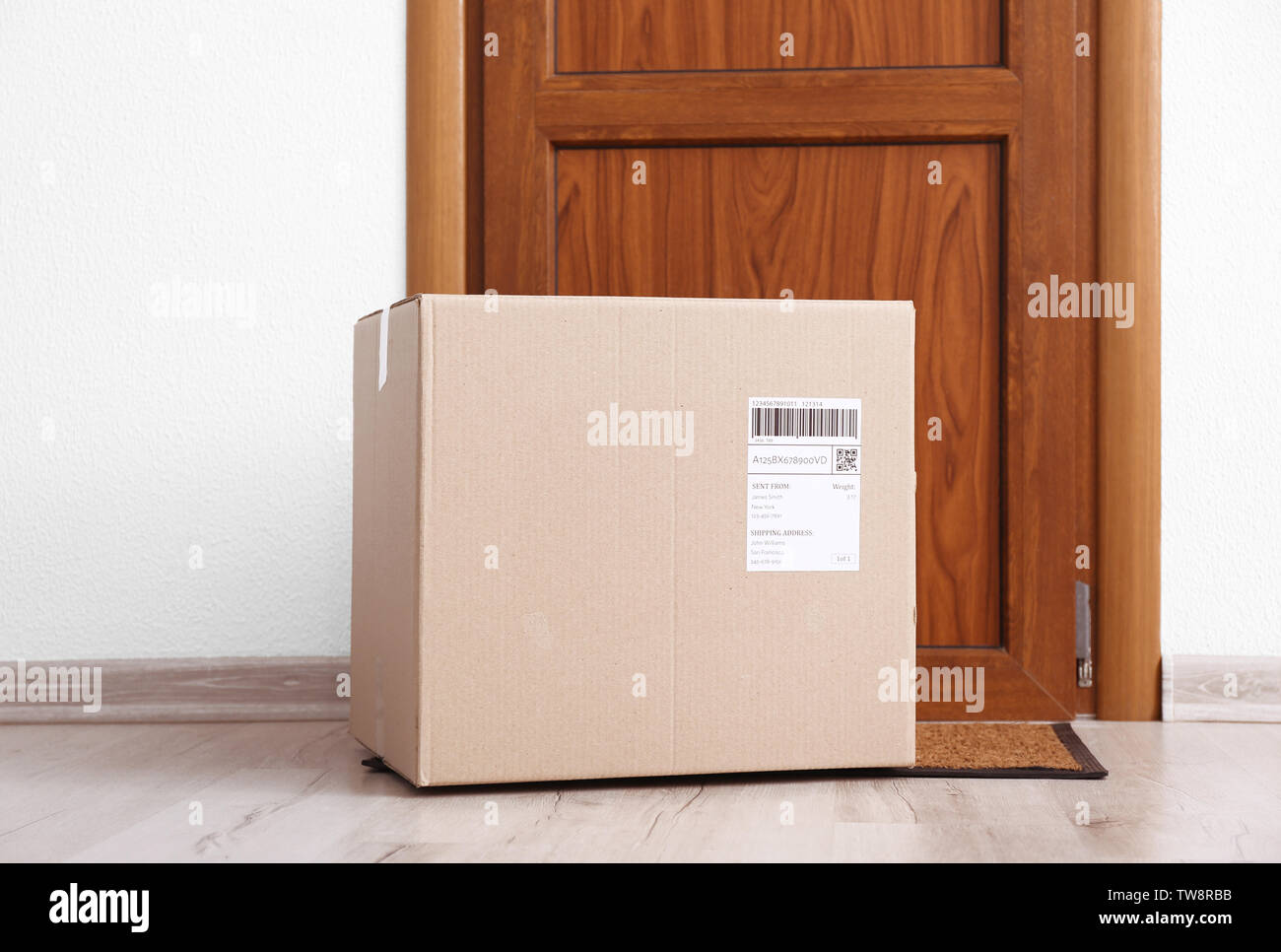 Parcel box on floor near door Stock Photo - Alamy