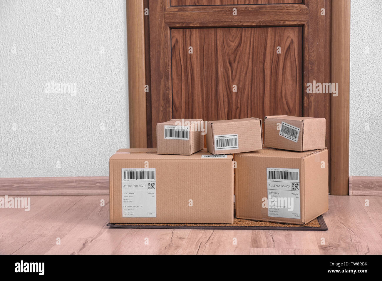 Parcel boxes on floor near door Stock Photo - Alamy