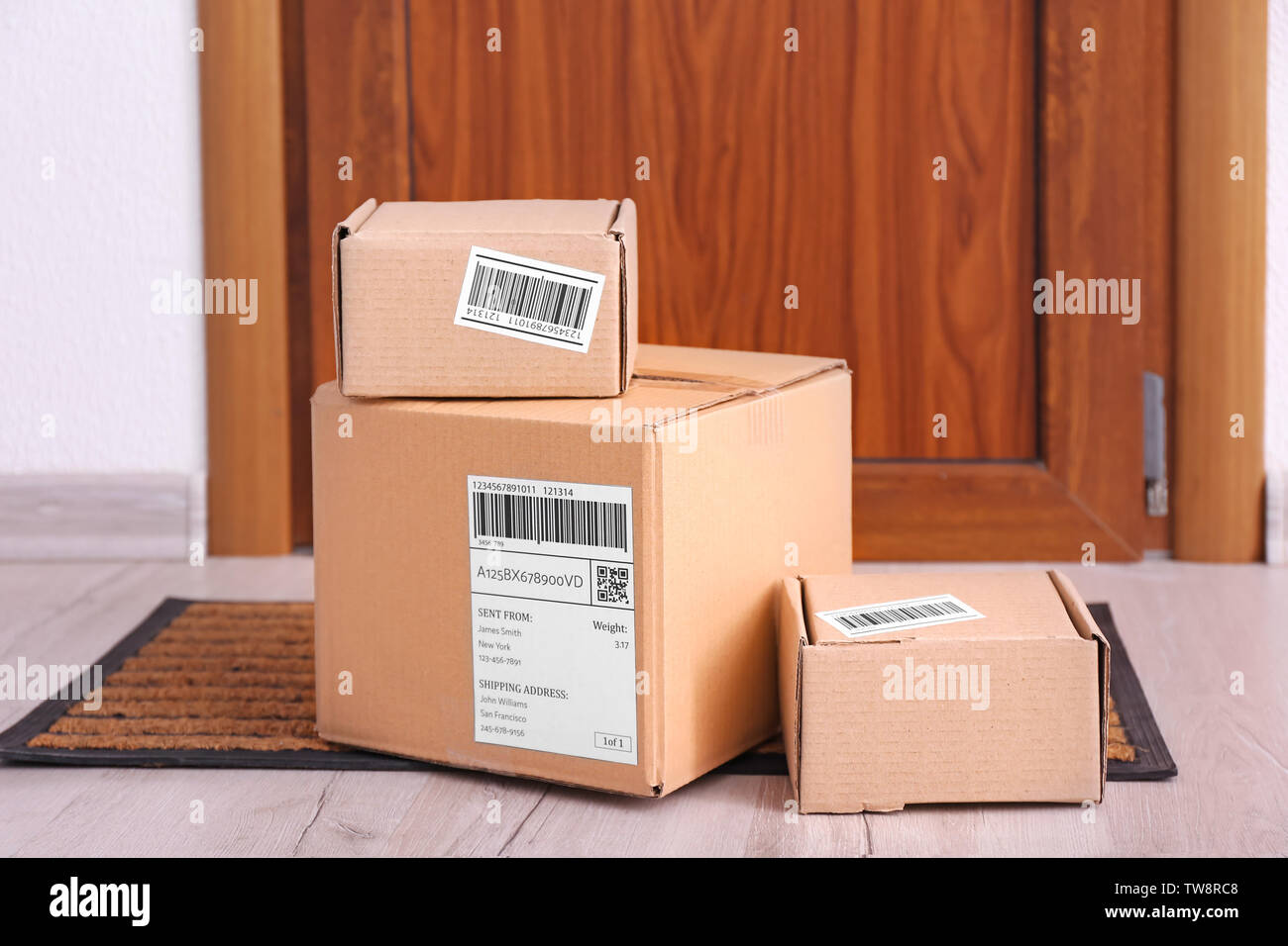 Parcel boxes on floor near door Stock Photo - Alamy