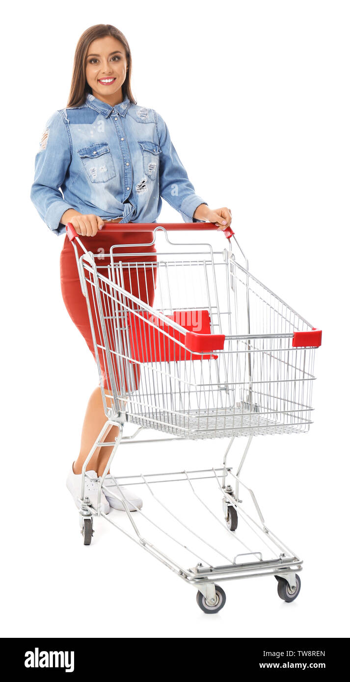 Young woman with empty shopping cart on white background Stock Photo ...