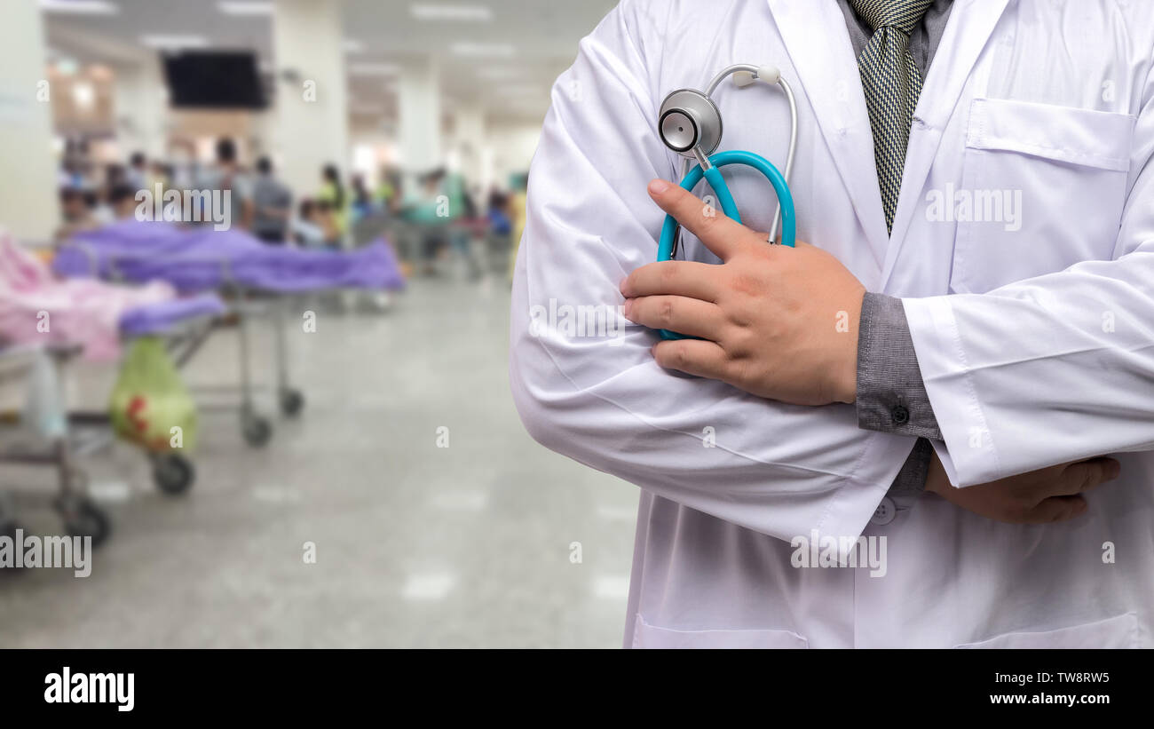 Doctor in gown uniform with stethoscope standing and fold his arms over ...