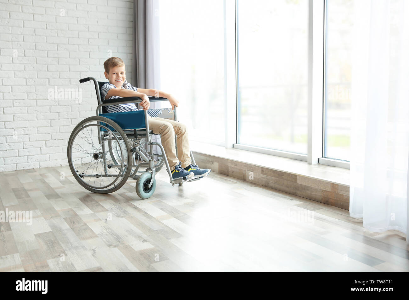 Little boy in wheelchair indoors Stock Photo - Alamy