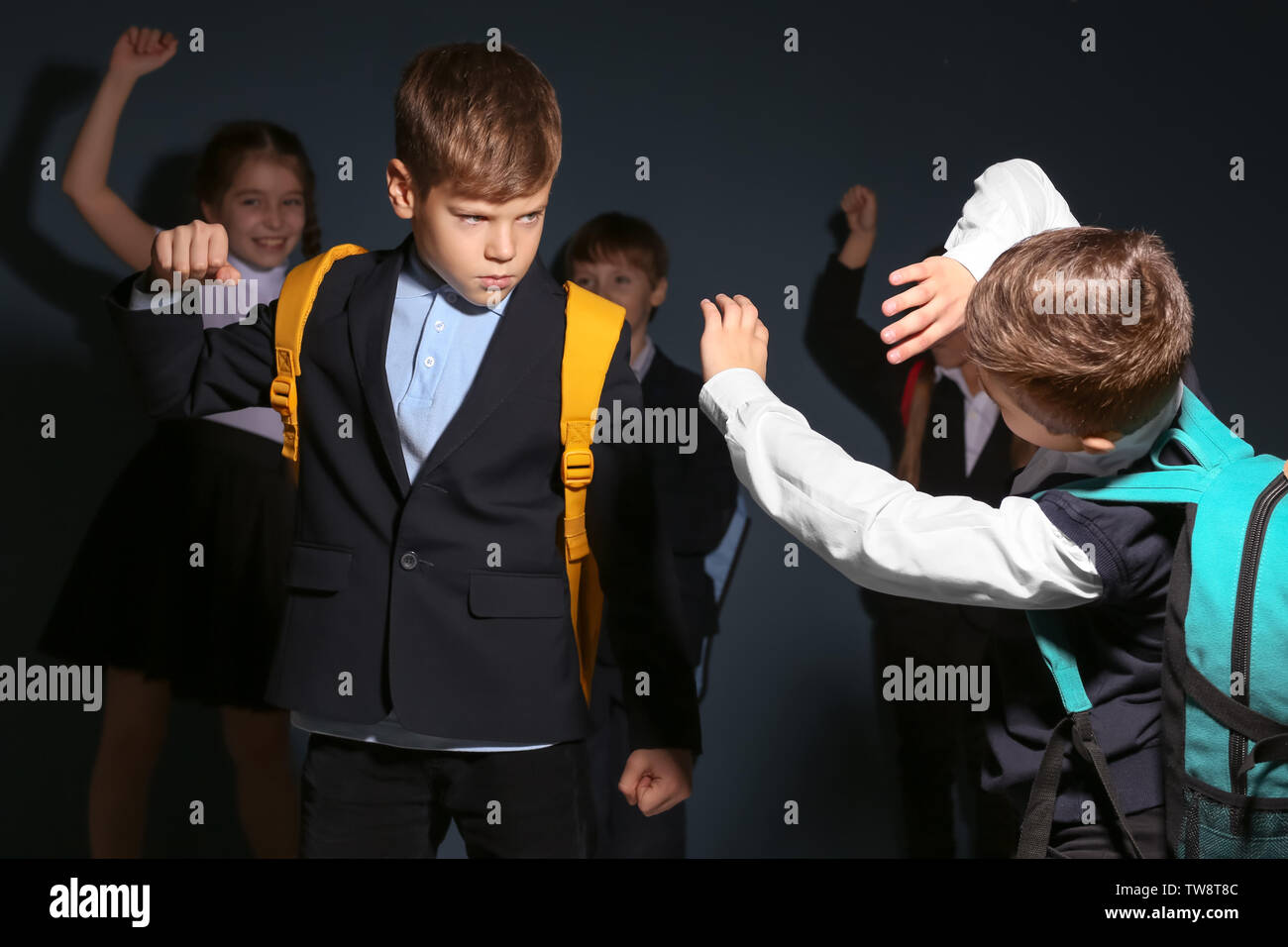 Little boy bullying his classmate on dark background Stock Photo - Alamy