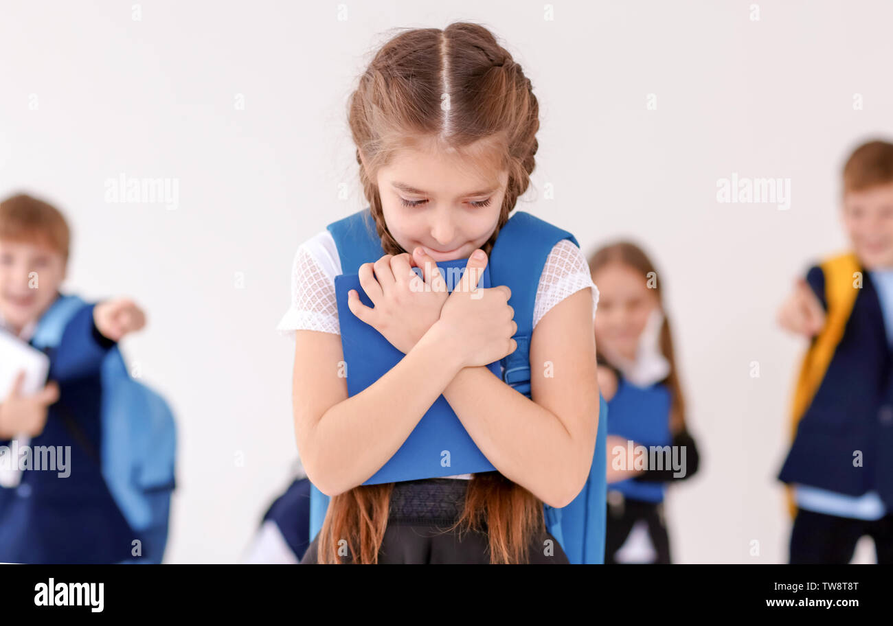 Children bullying their classmate on light background Stock Photo - Alamy
