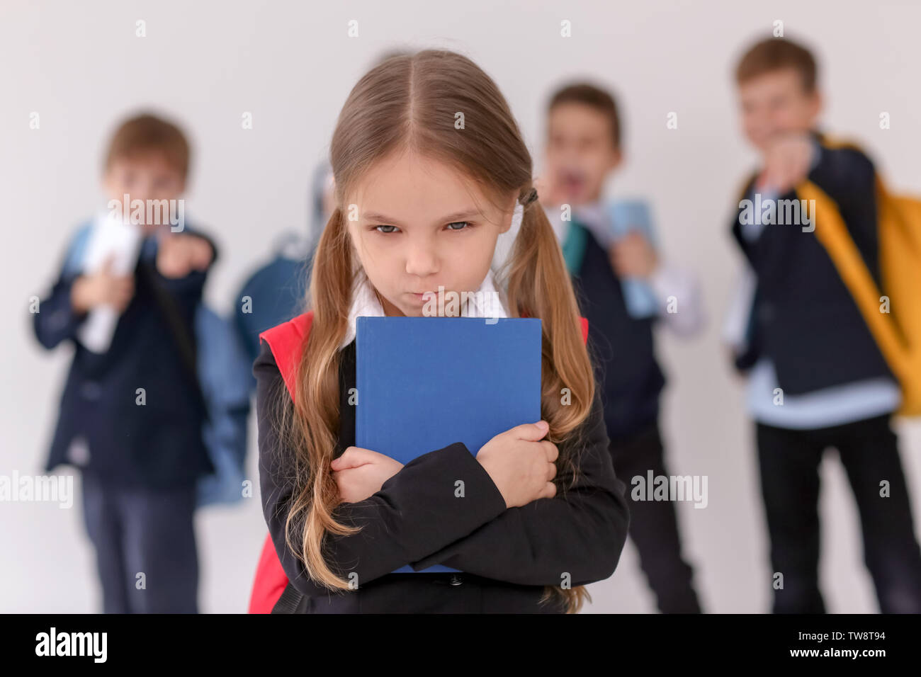 Children bullying their classmate on light background Stock Photo - Alamy