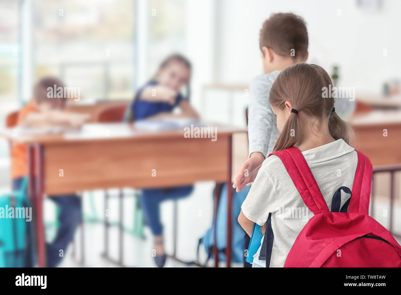 Boy protecting little girl from bullying in school Stock Photo - Alamy